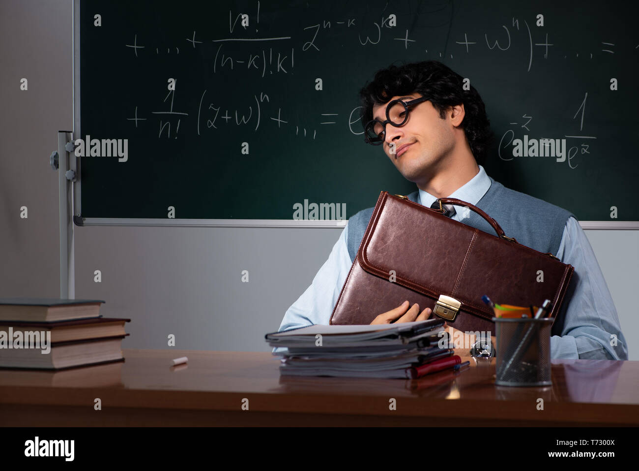 Young math teacher in front of chalkboard Stock Photo - Alamy