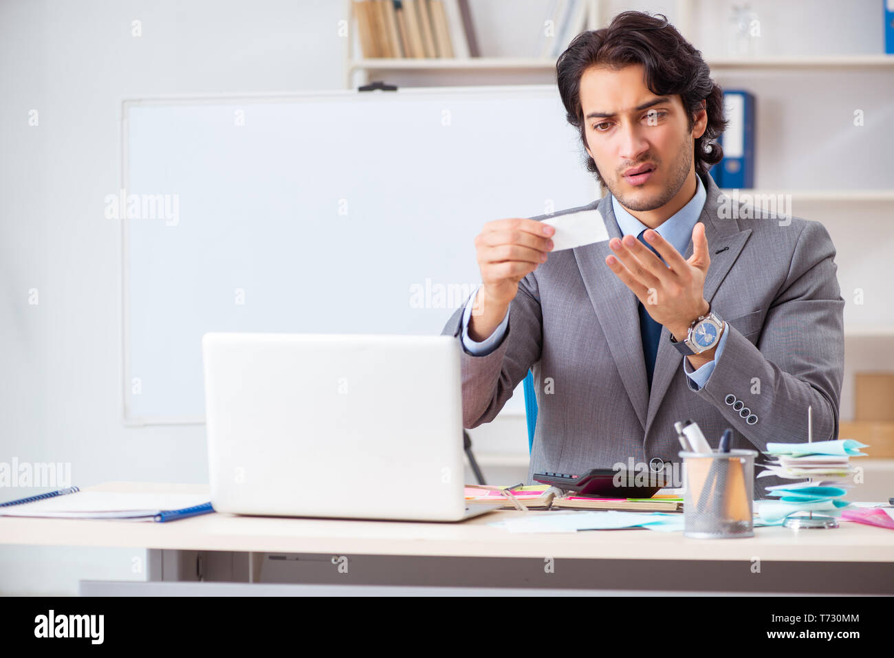 Young handsome businessman in budget planning concept Stock Photo - Alamy