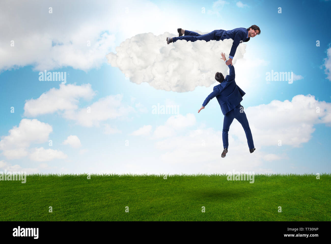 Businessman offering helping hand to falling colleague Stock Photo - Alamy