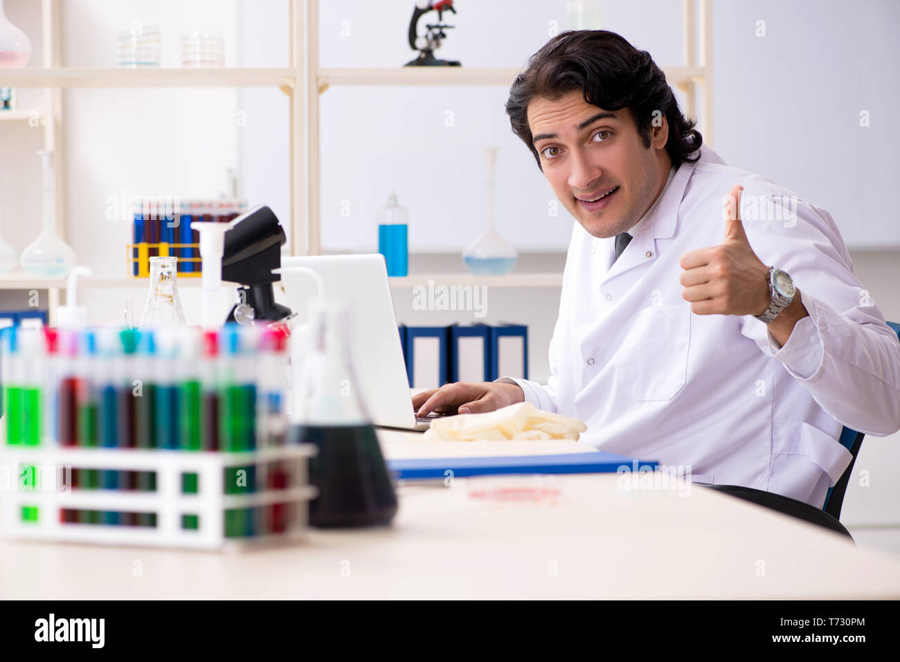 Happy young chemist mixing hi-res stock photography and images - Alamy