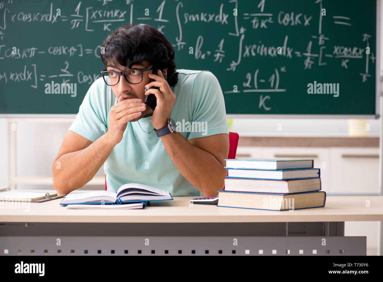 Young male student mathematician in front of chalkboard Stock Photo - Alamy