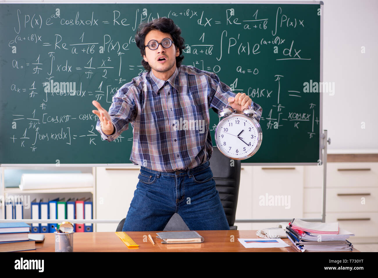 Funny male math teacher in the classroom Stock Photo - Alamy