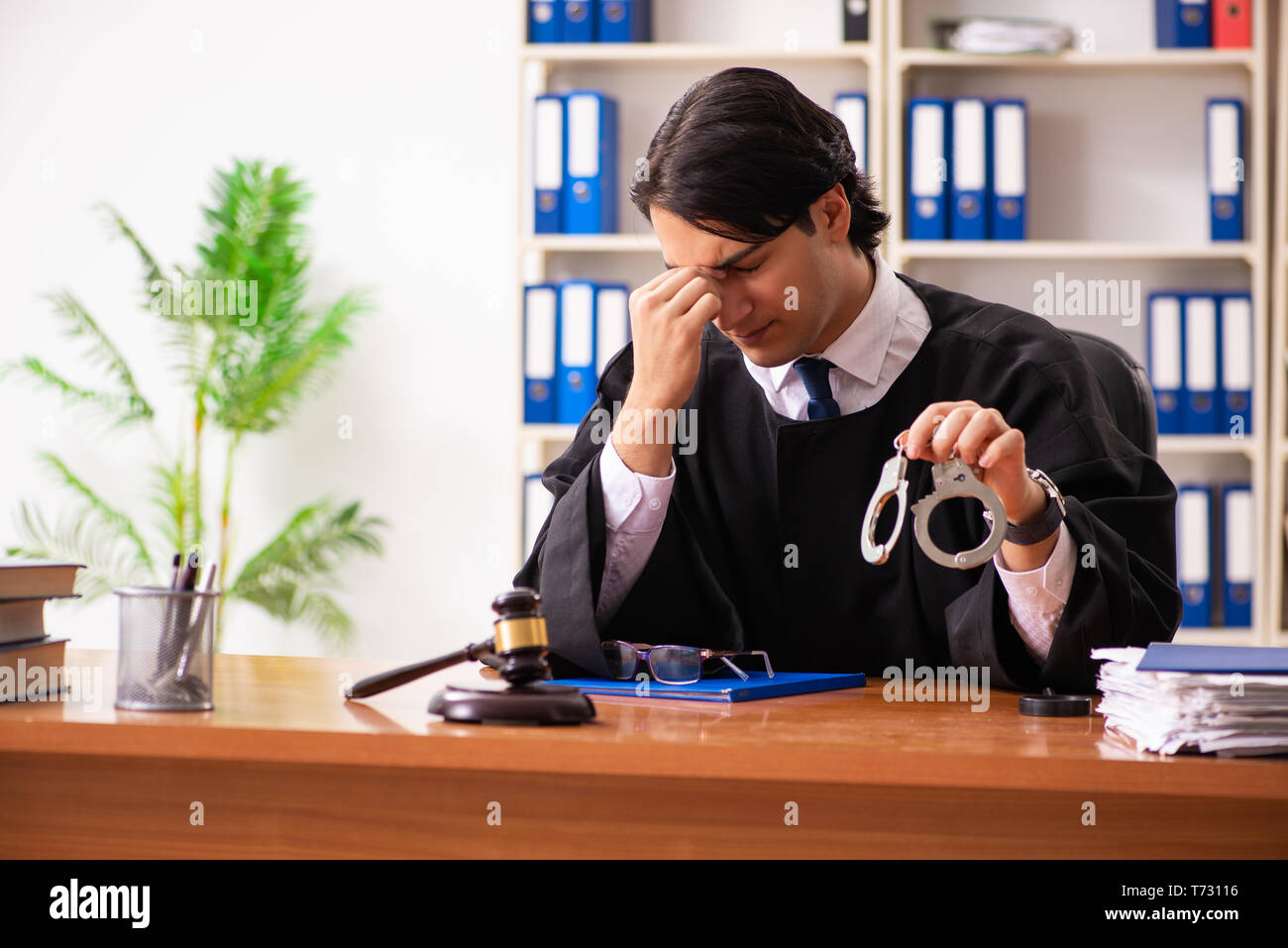 Young handsome judge working in court Stock Photo - Alamy