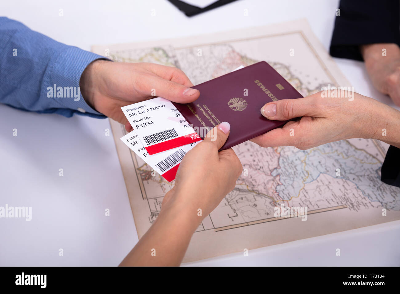 Close Up Of Humans Hand Holding Passport And Boarding Pass In Office