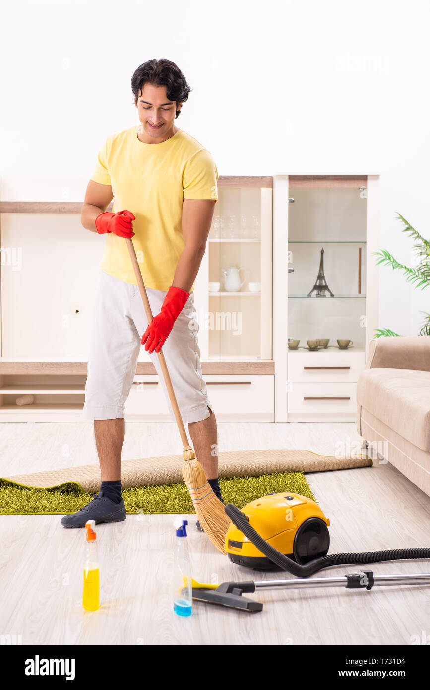 Happy smiling young man sweeping hi-res stock photography and images ...