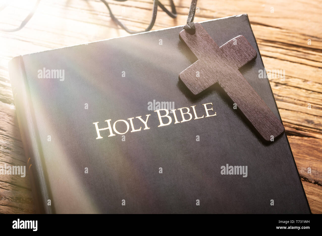Wooden Christian Cross On Holy Bible Over Wooden Table Stock Photo - Alamy
