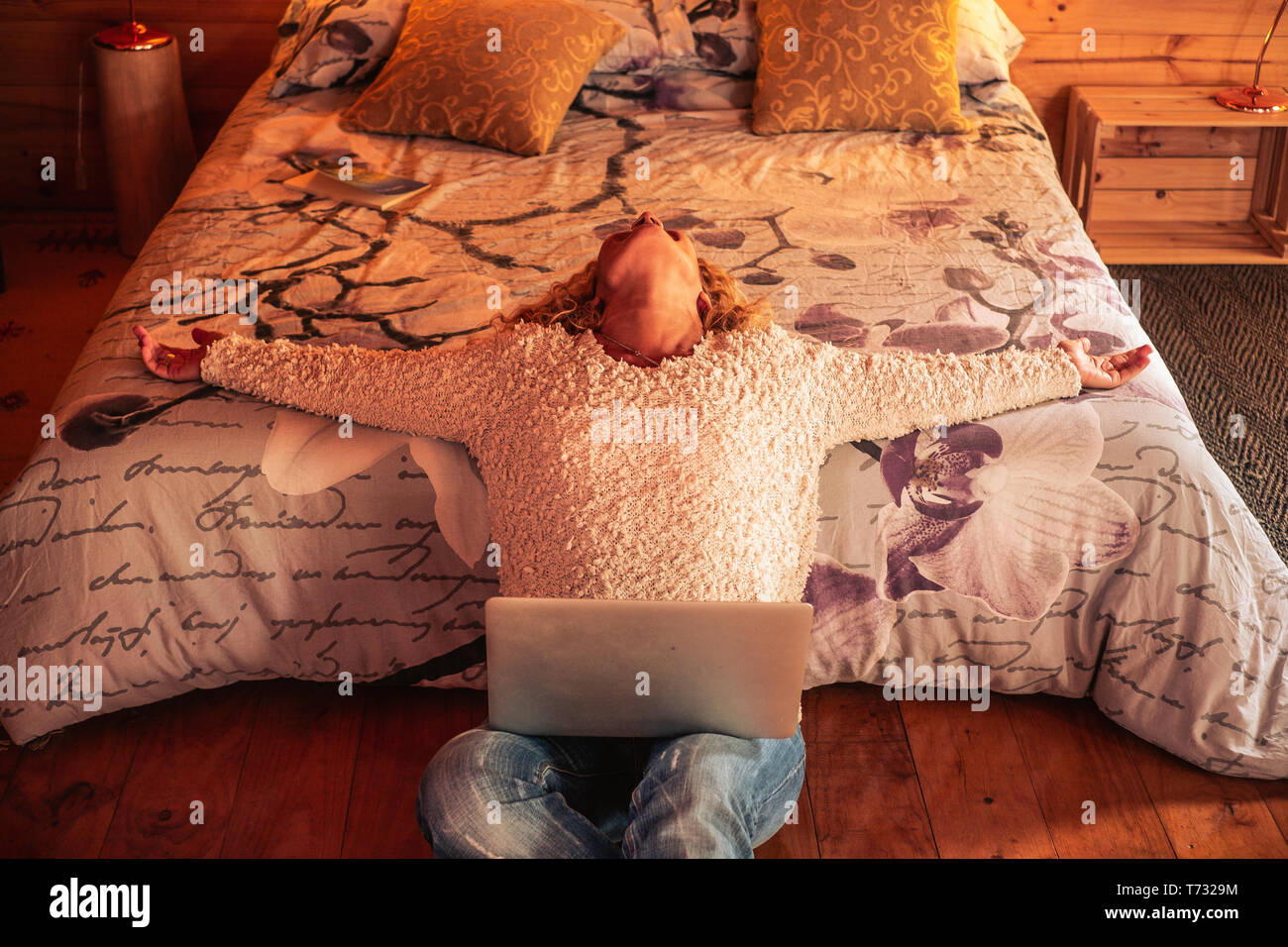 Happy joyful beautiful people woman sit down in the bedroom with laptop ...
