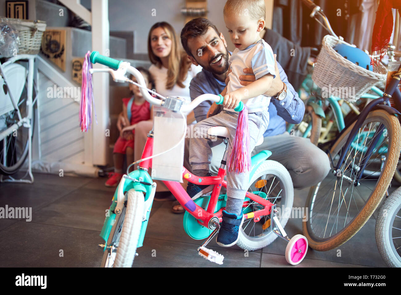 Father buying new bicycle for happy boy in bike shop Stock Photo - Alamy