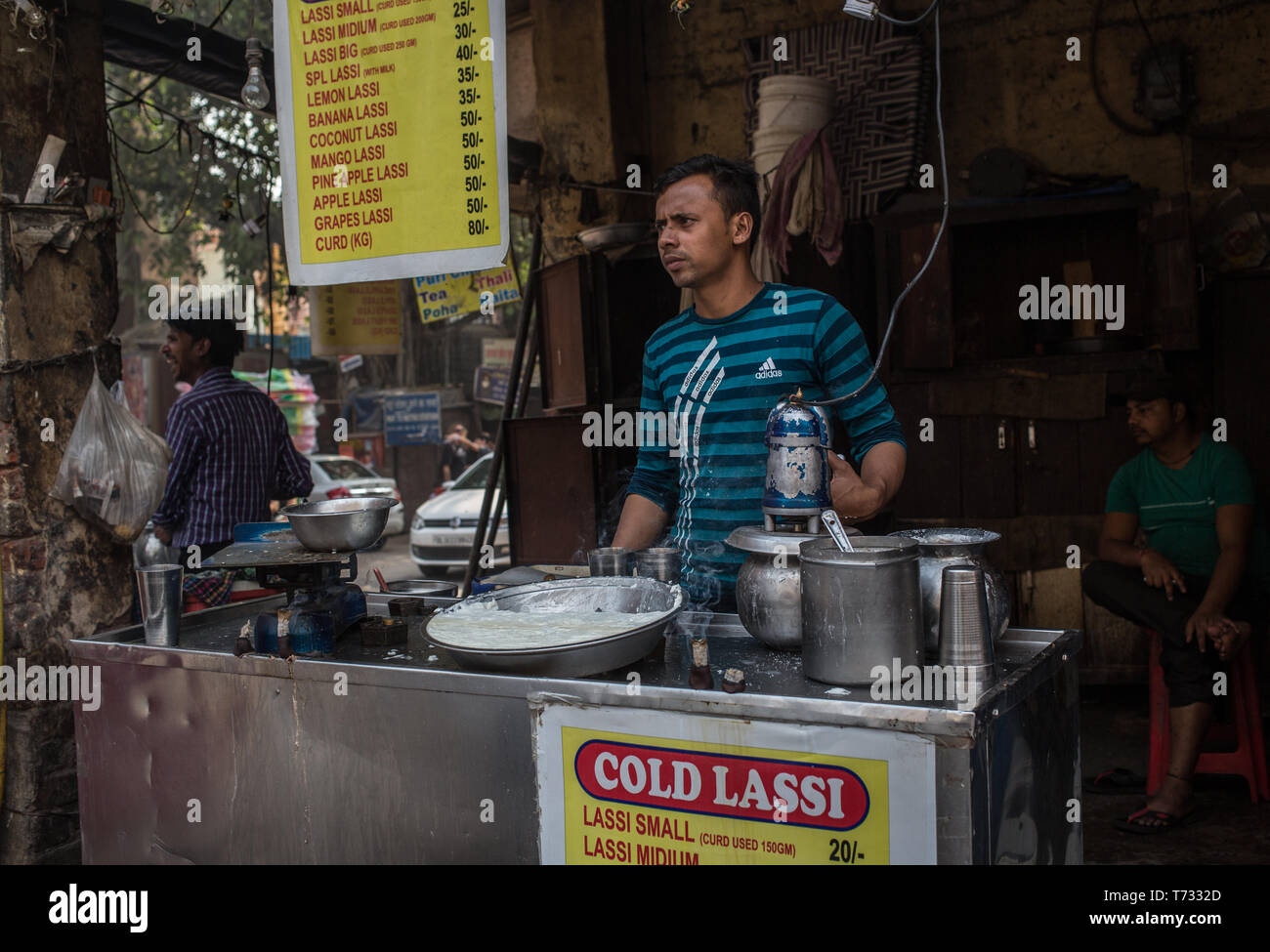A man selling Lassi, an traditional Indian yoghurt drink, at a street ...
