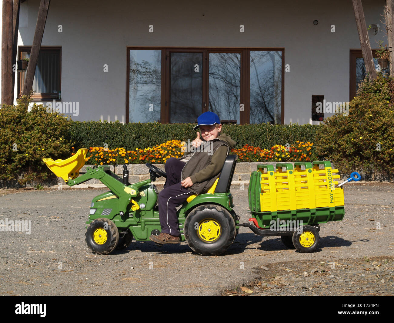Little boy playing with toy-tractor Stock Photo - Alamy