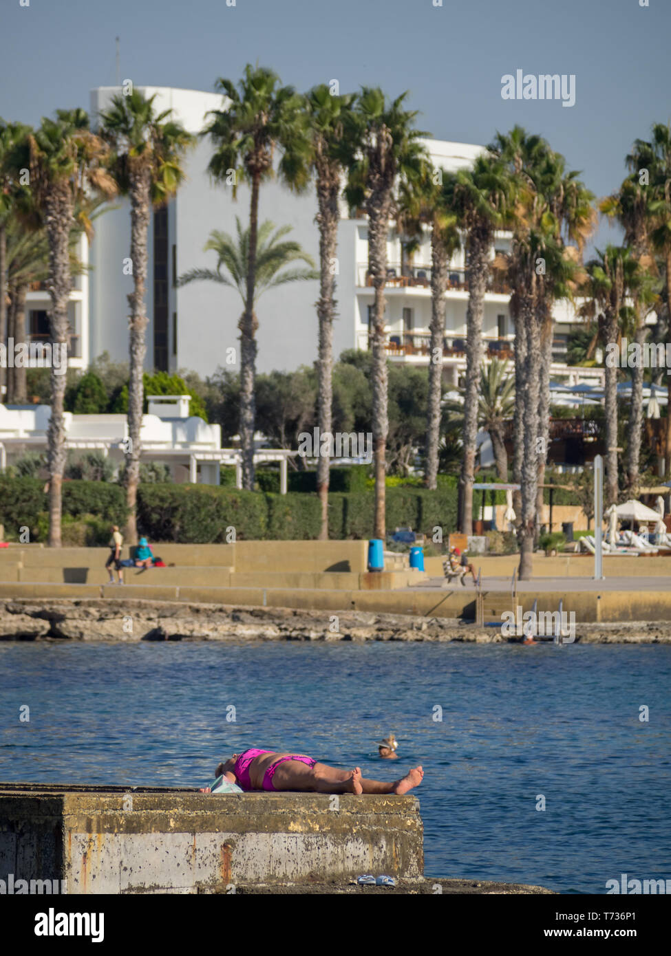 Sunbathing in the jetty by Paphos harbour Stock Photo - Alamy