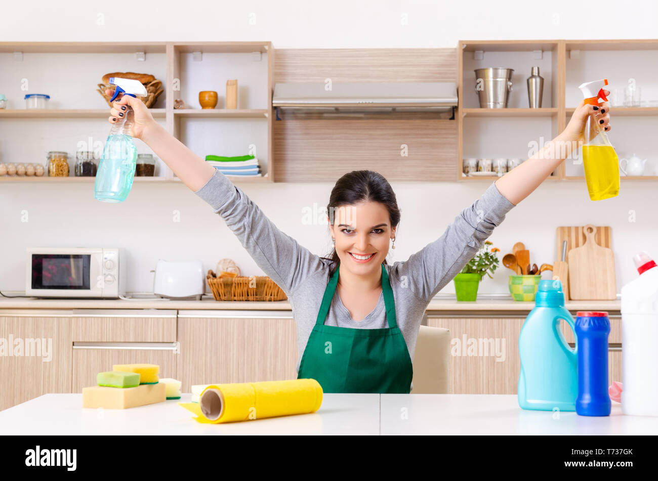 Young female contractor doing housework Stock Photo - Alamy
