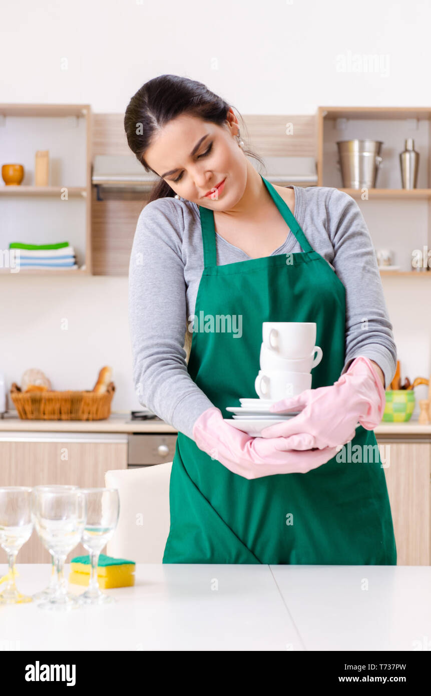 Young female contractor doing housework Stock Photo - Alamy