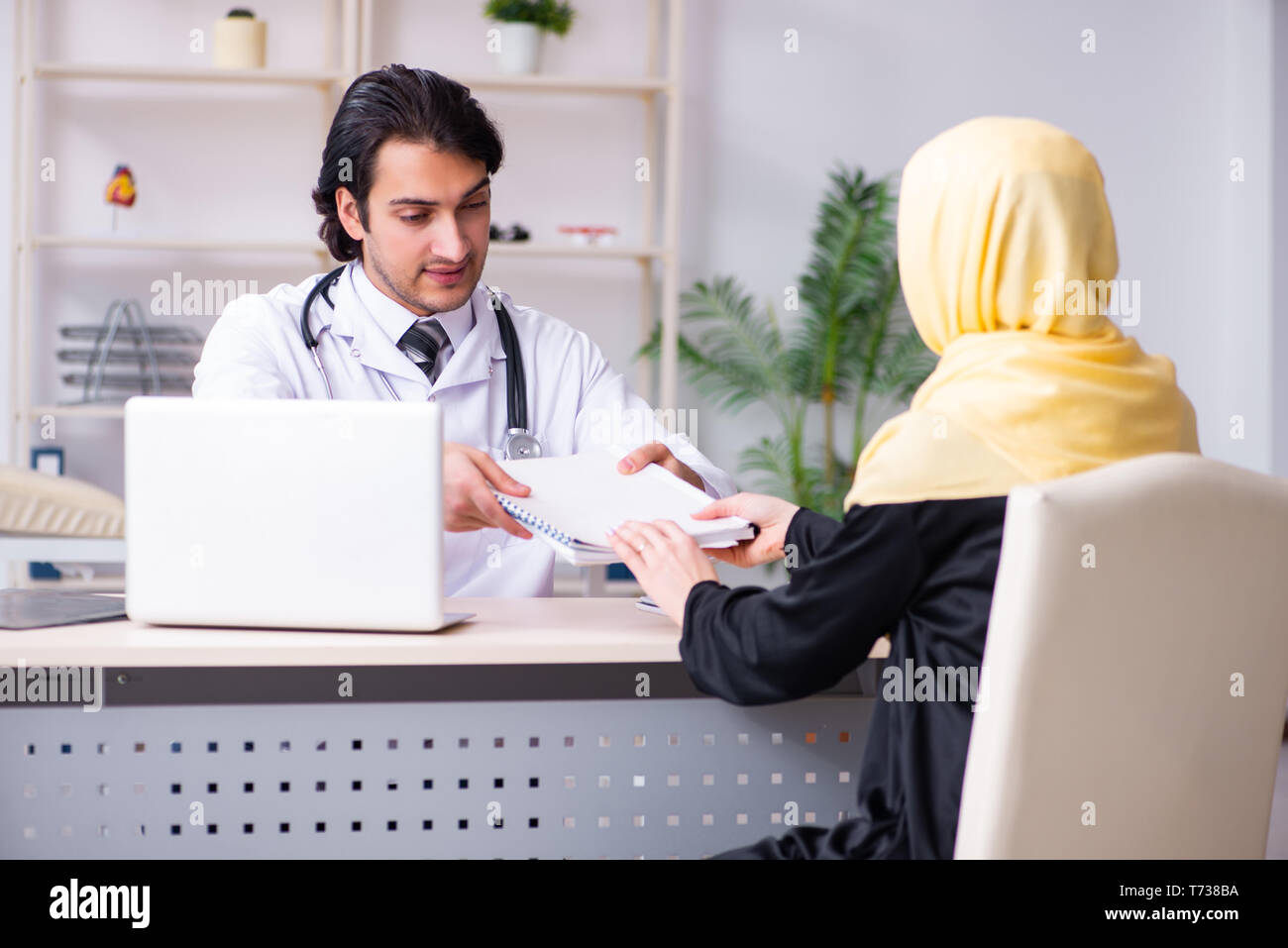 Female arab patient visiting male doctor Stock Photo - Alamy