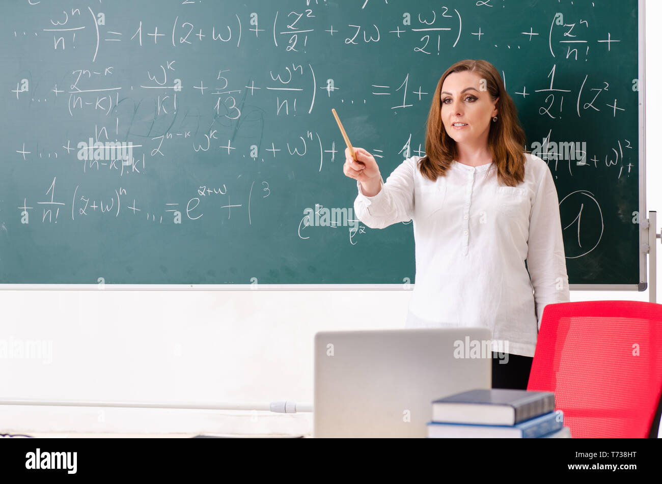 Female math teacher in the classroom Stock Photo - Alamy