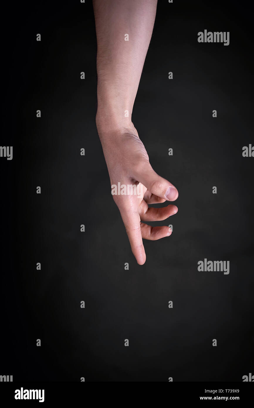 Man hand pointing on a dark background Stock Photo - Alamy