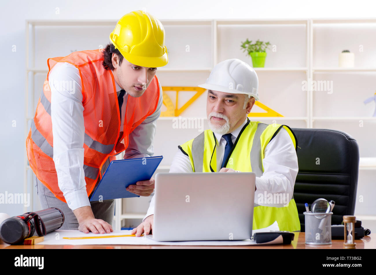 Two engineers colleagues working under project Stock Photo - Alamy