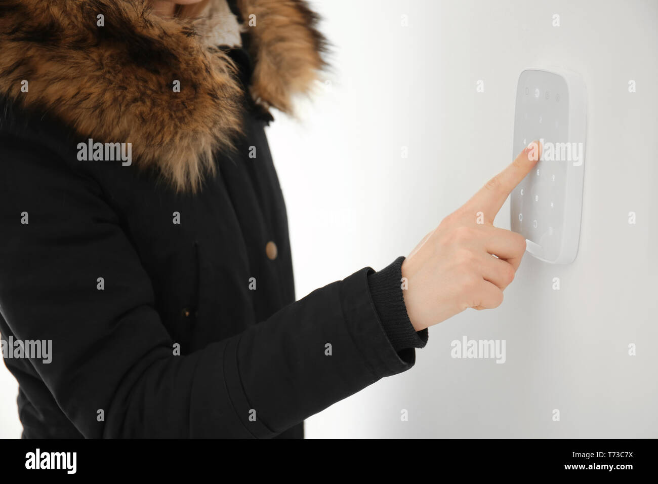 Woman using security system indoors Stock Photo - Alamy