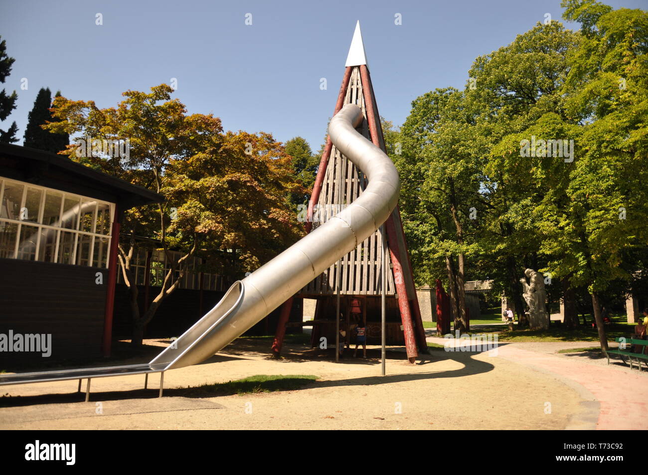 A curved silver slide in the park Stock Photo - Alamy