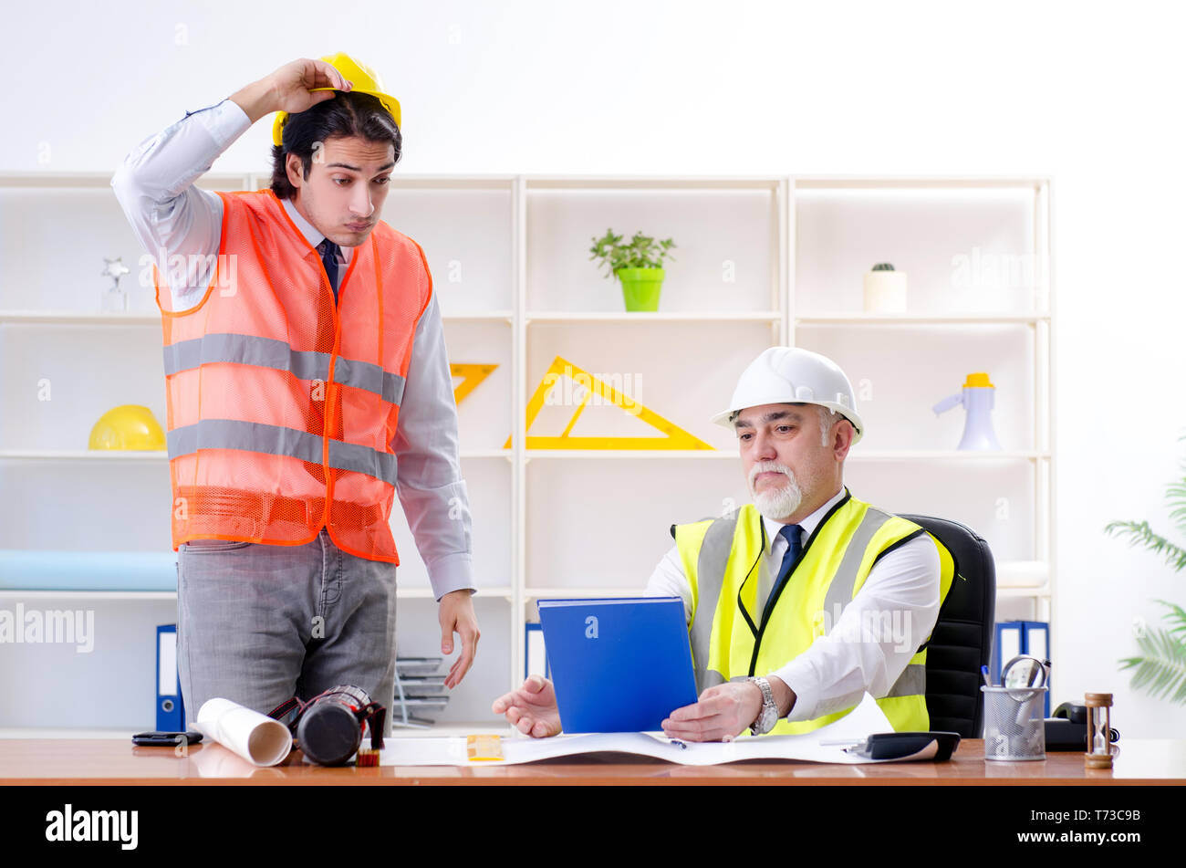 Two engineers colleagues working under project Stock Photo - Alamy