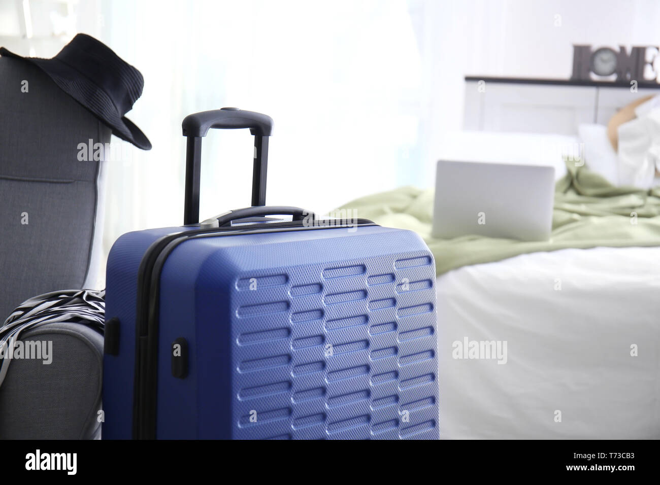 Large blue suitcase prepared for journey indoors Stock Photo - Alamy
