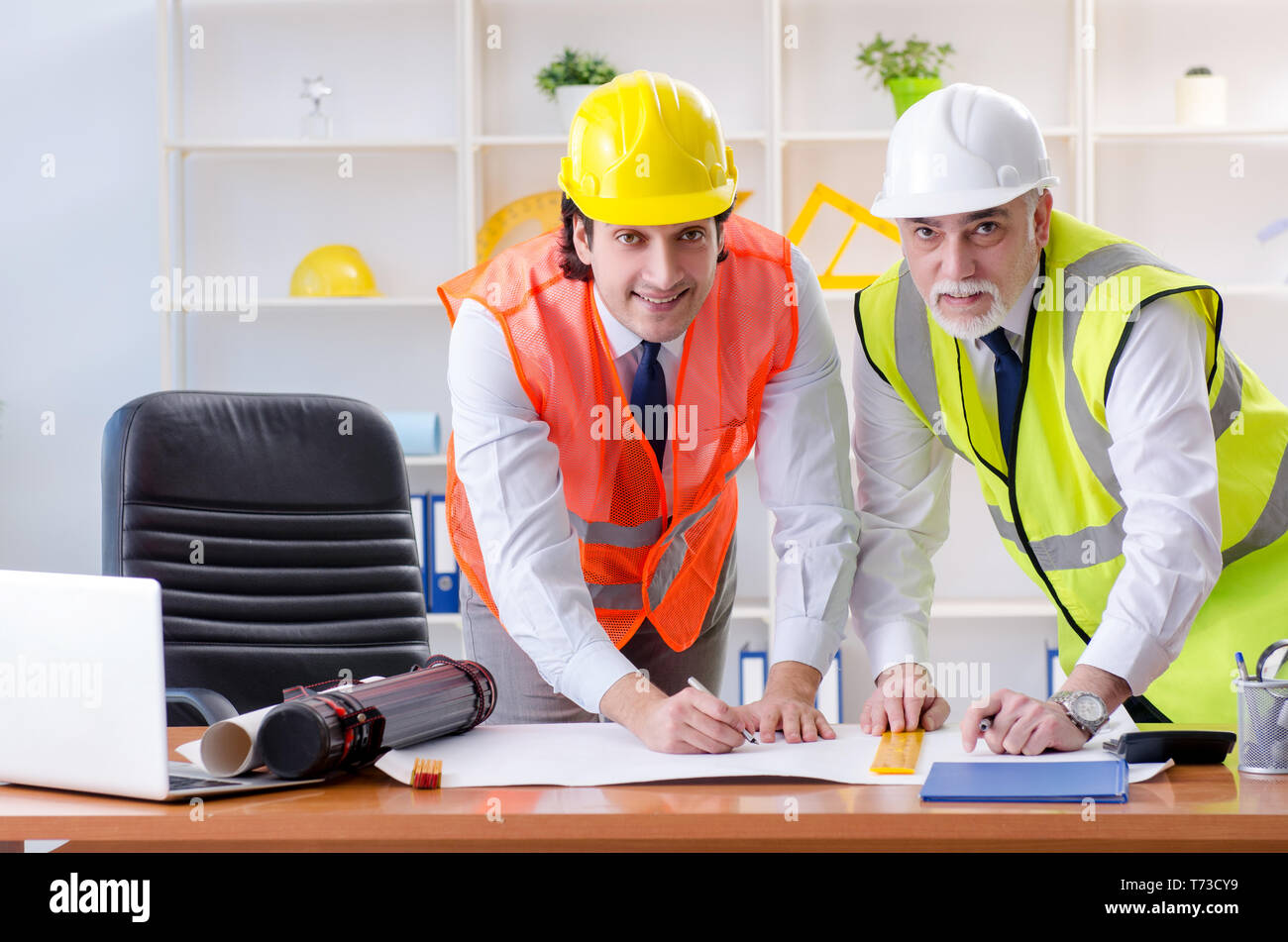 Two engineers colleagues working under project Stock Photo - Alamy
