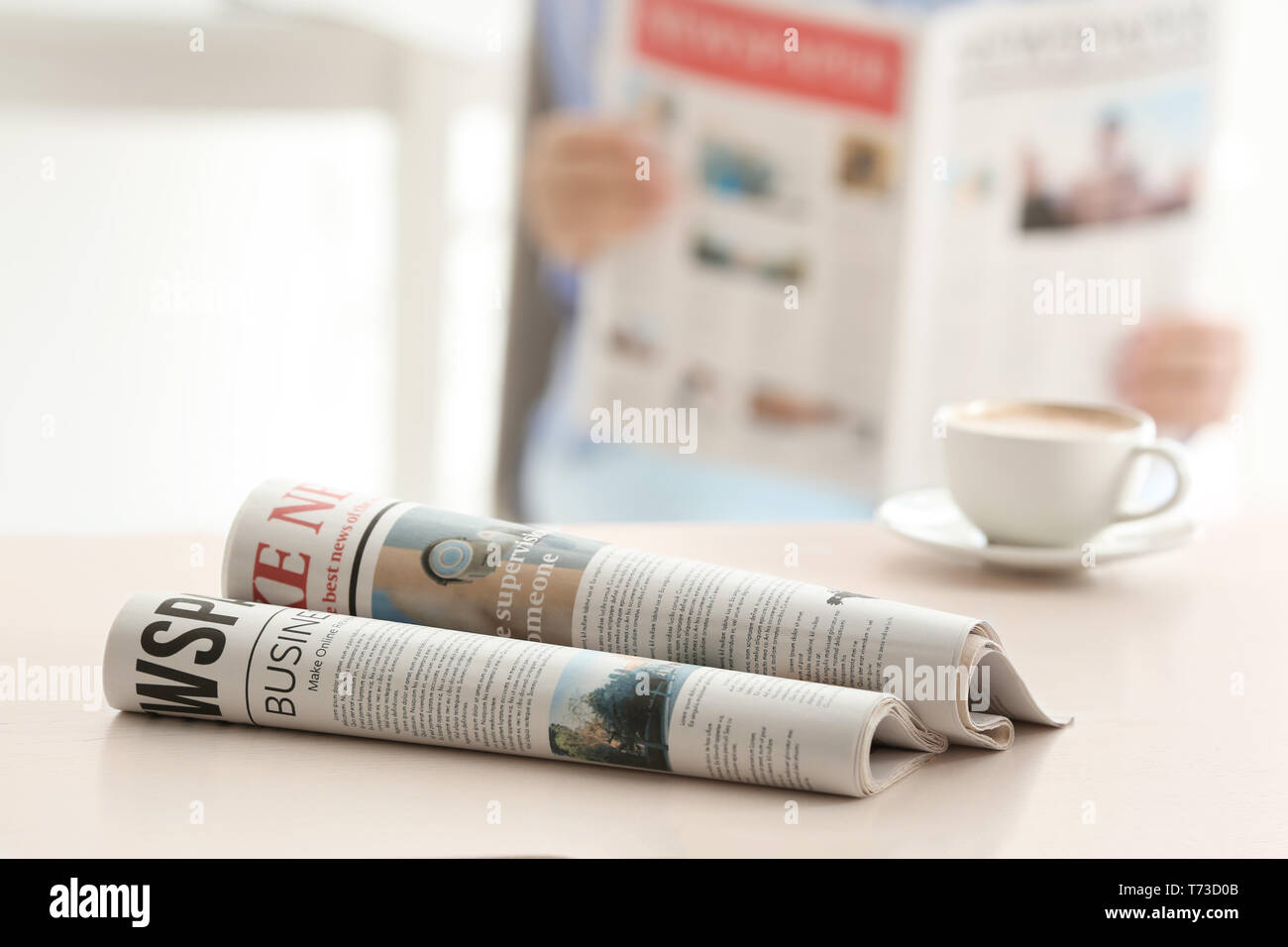 Morning newspapers on white table Stock Photo - Alamy
