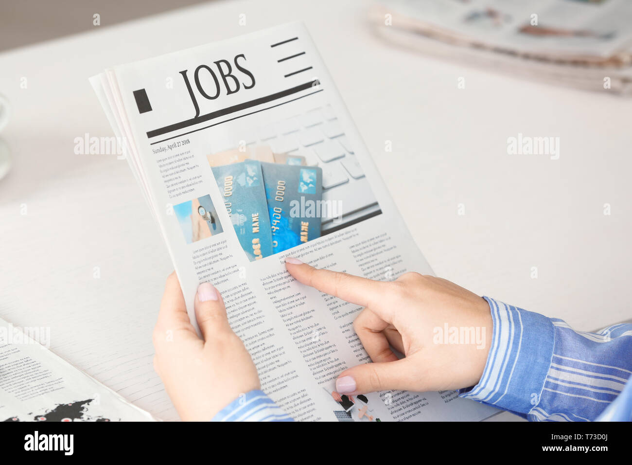 Woman reading morning newspaper indoors Stock Photo - Alamy