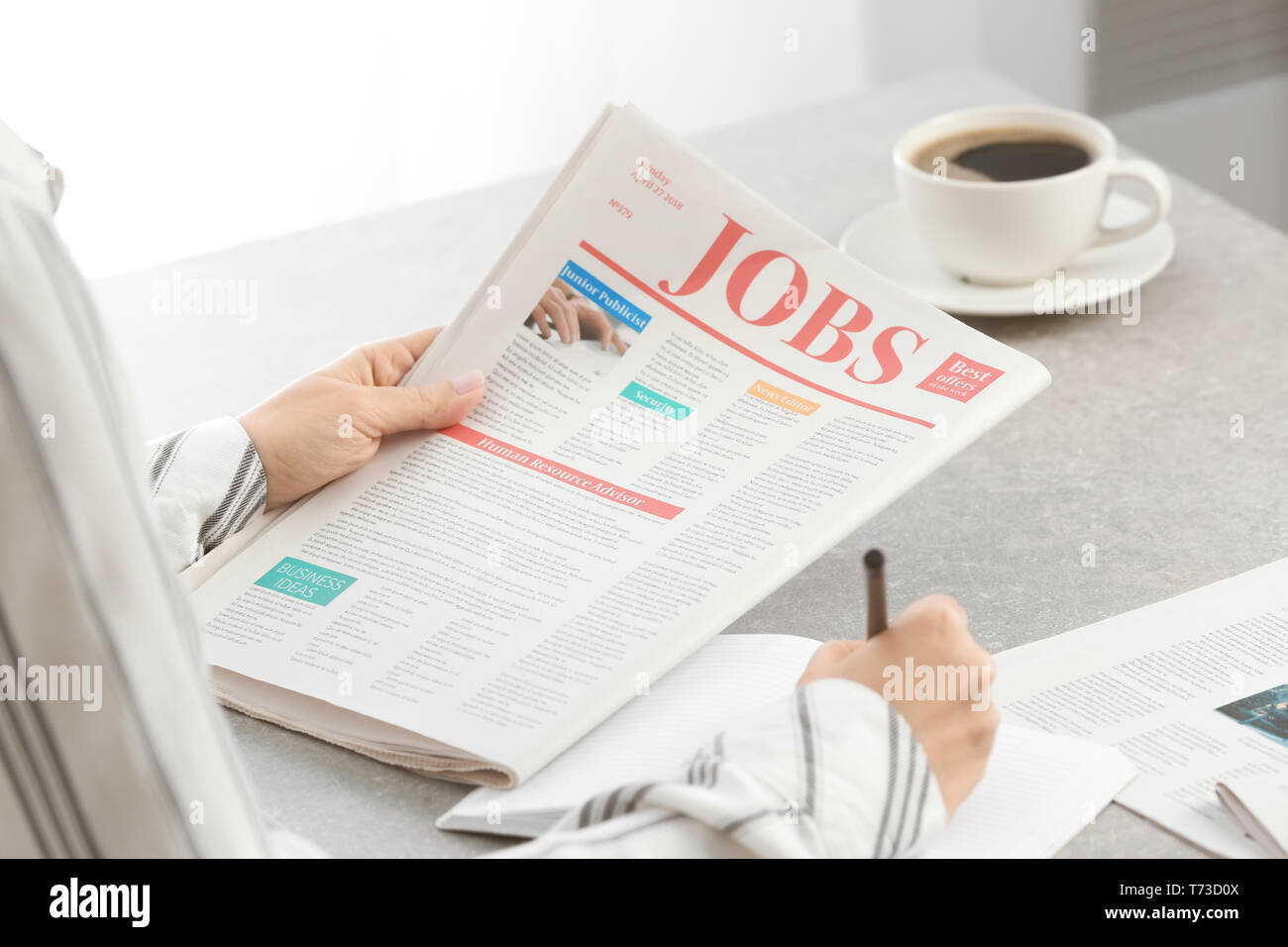Woman reading morning newspaper indoors Stock Photo - Alamy
