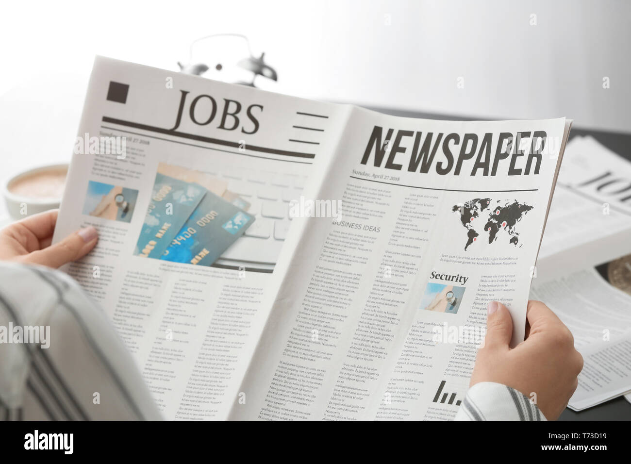 Woman reading morning newspaper indoors Stock Photo - Alamy