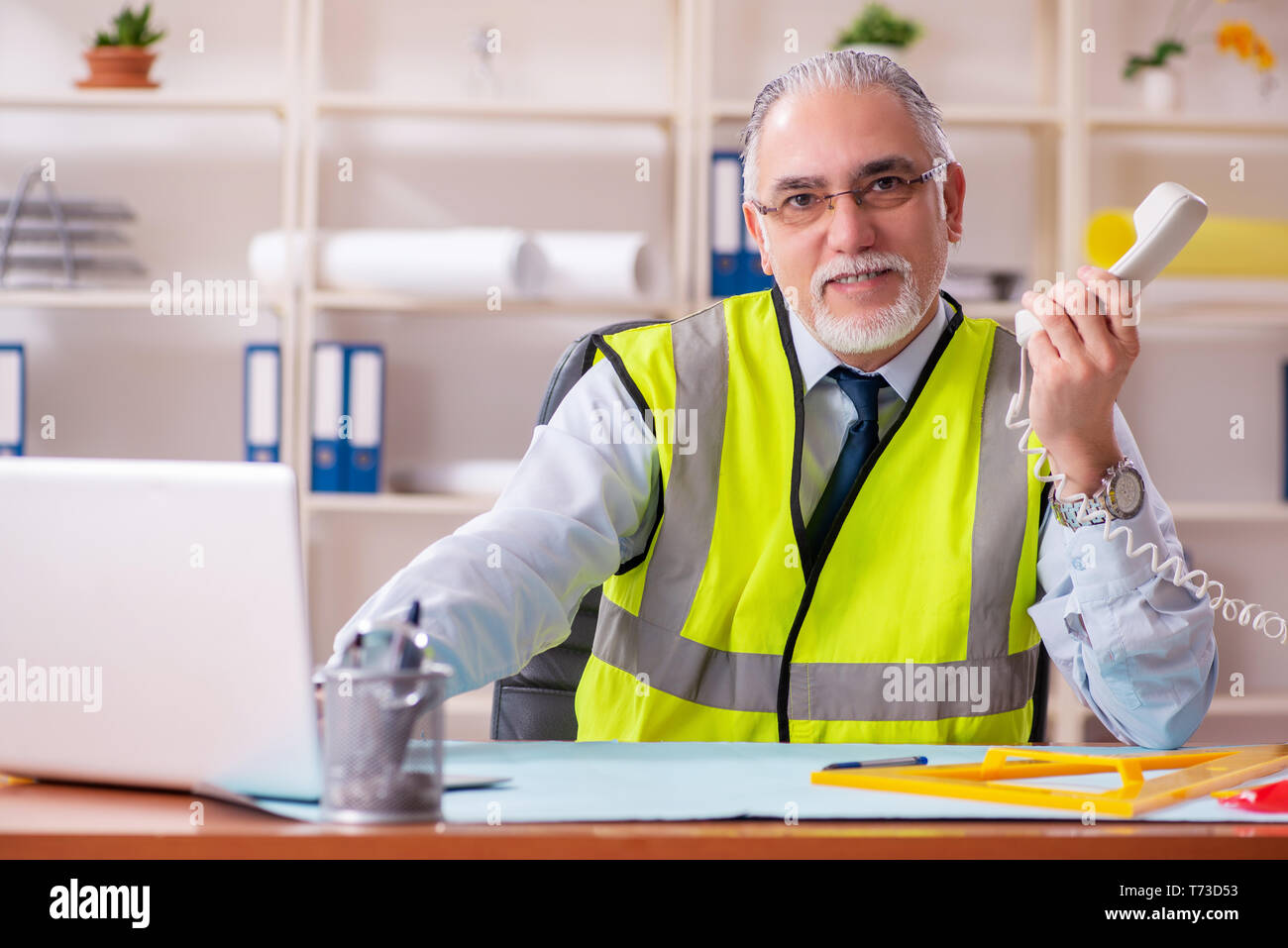Aged construction engineer working in the office Stock Photo - Alamy