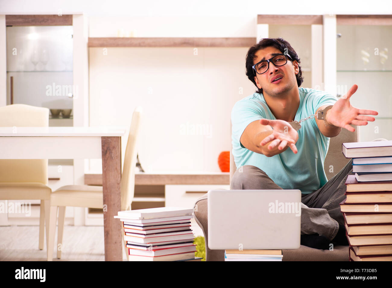 Frustrated boy with stack of books hi-res stock photography and images ...