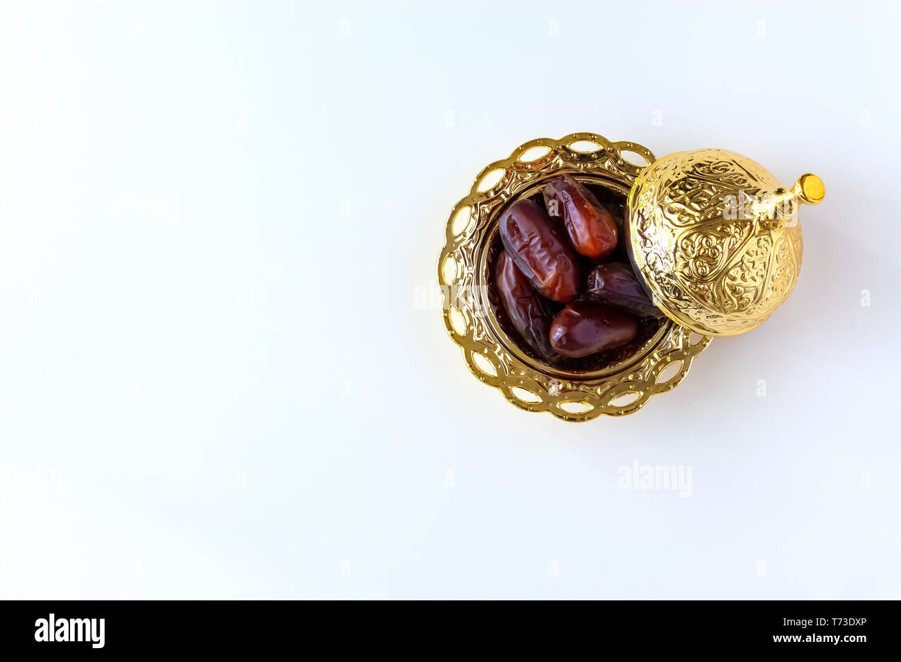 Organic dried dates in traditional arabic golden plate. Holy month ...