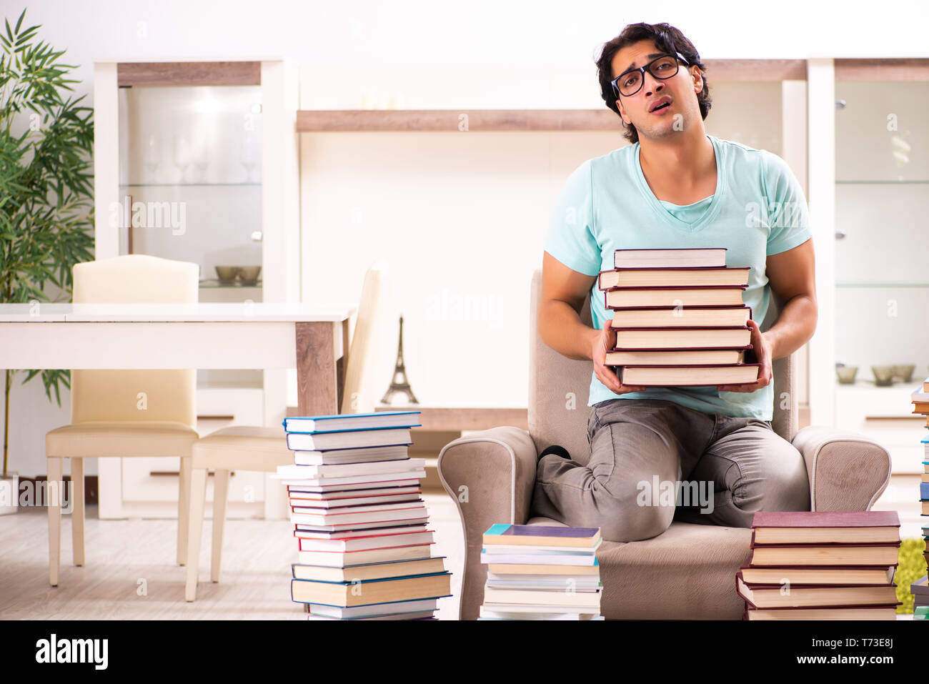 Frustrated boy with stack of books hi-res stock photography and images ...
