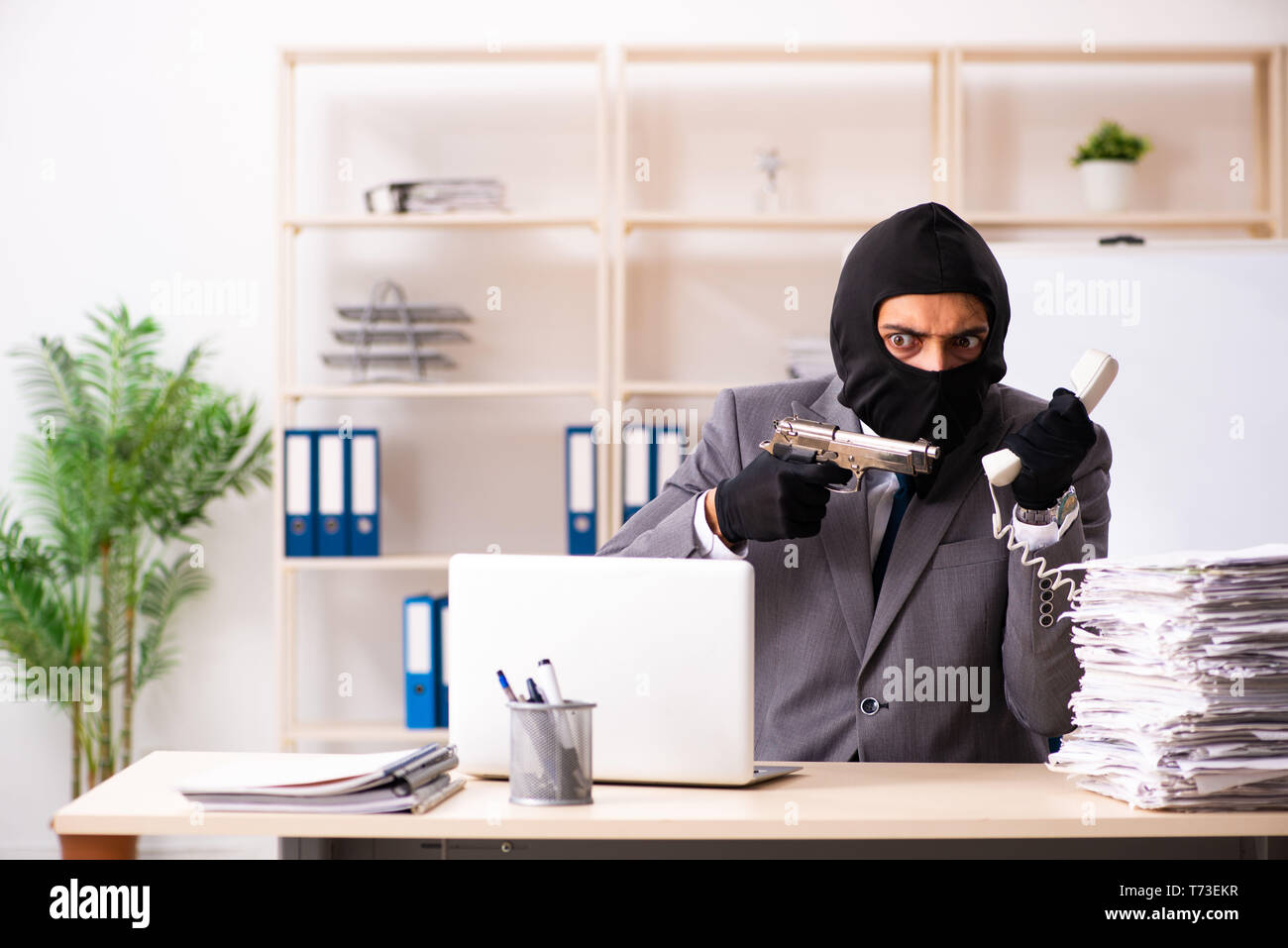 Male gangster stealing information from the office Stock Photo - Alamy