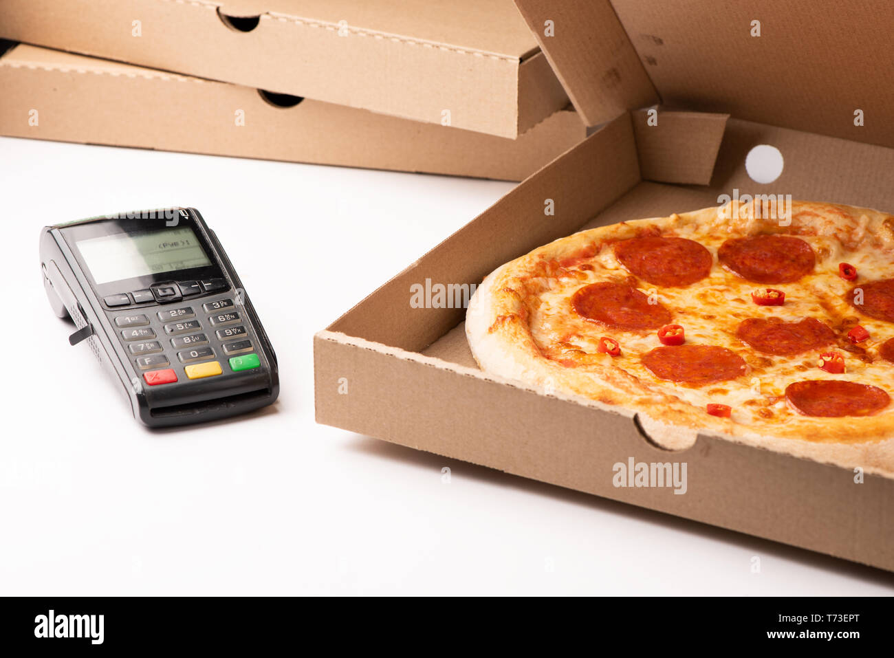 Take away Pizza payment with credit card through terminal close up ...
