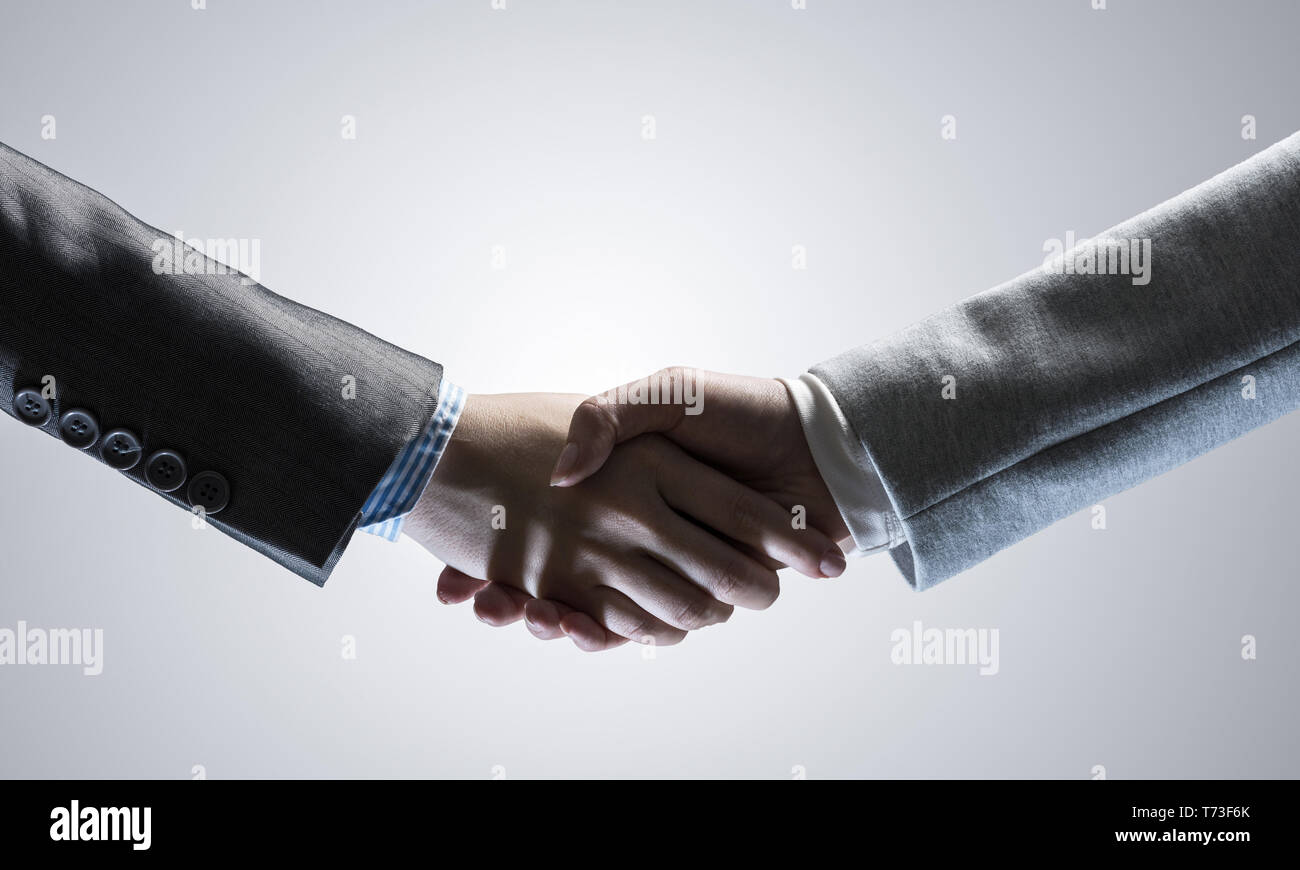 Business handshake as idea for unity and cooperation or greeting. Mixed ...