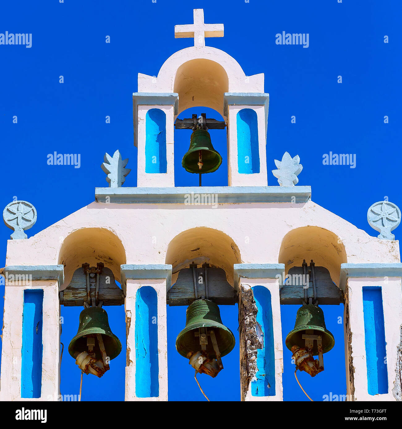 Greek orthodox church bell tower against blue sky, Santorini, Greece ...