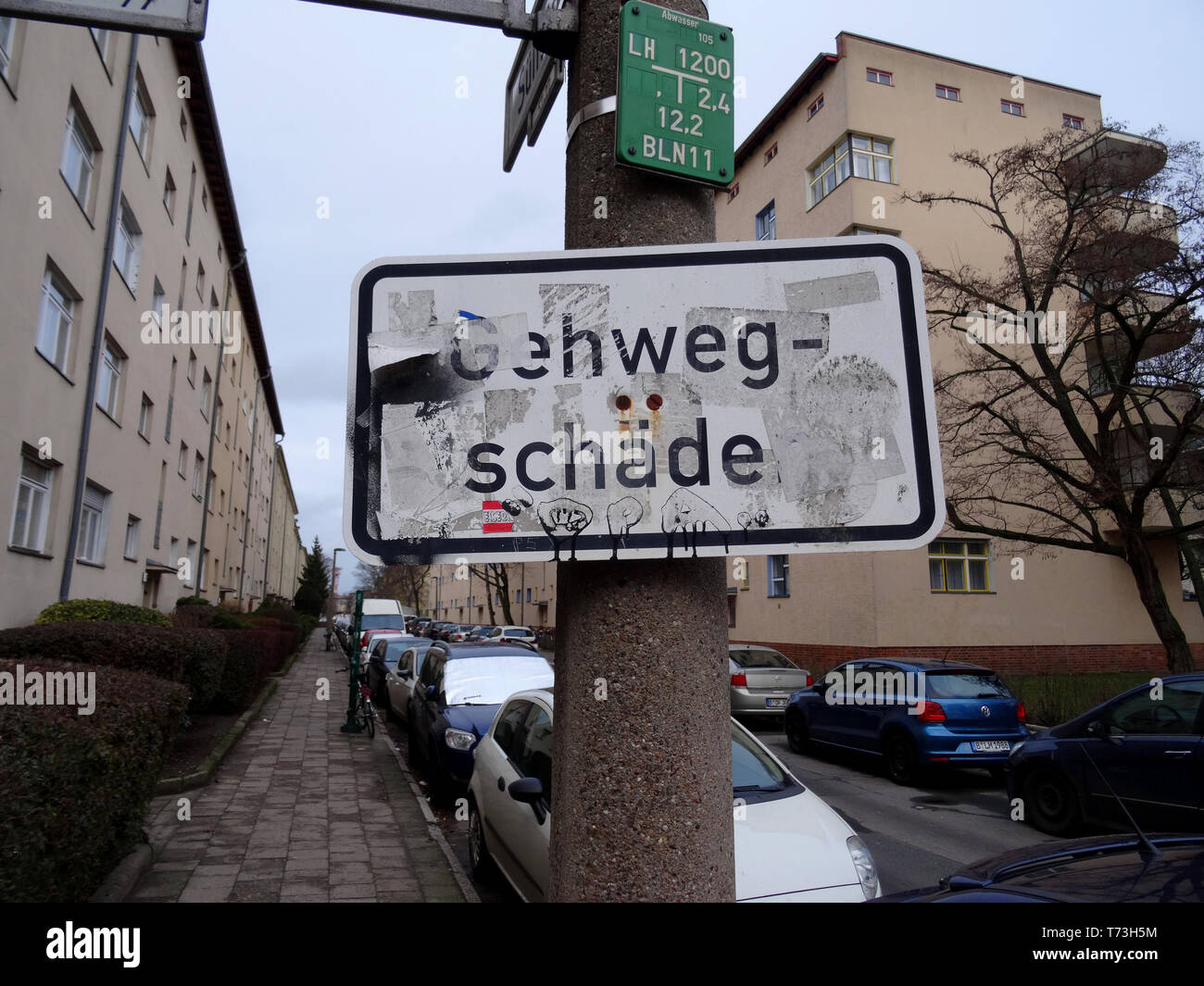 Street sign in front of buildings. Attention for road users because of ...