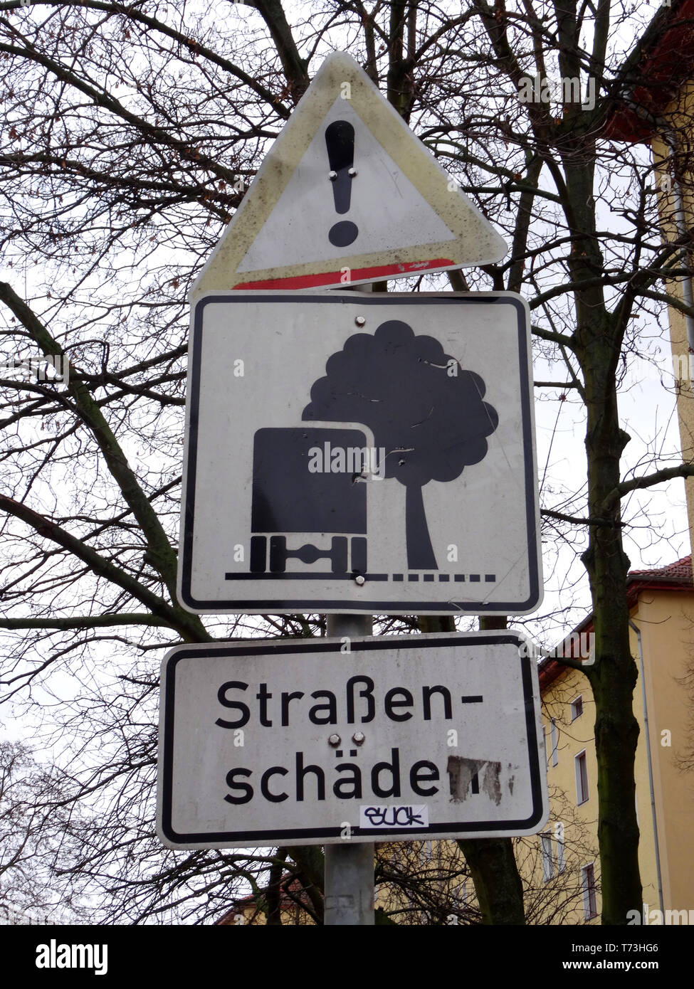 Street sign in front of buildings. Attention for road users because of ...