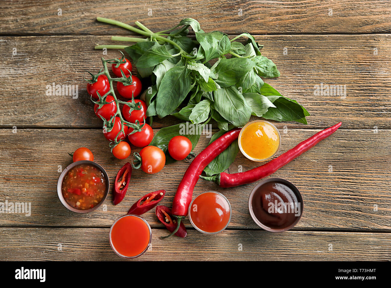Flat lay composition with different sauces and ingredients on wooden ...