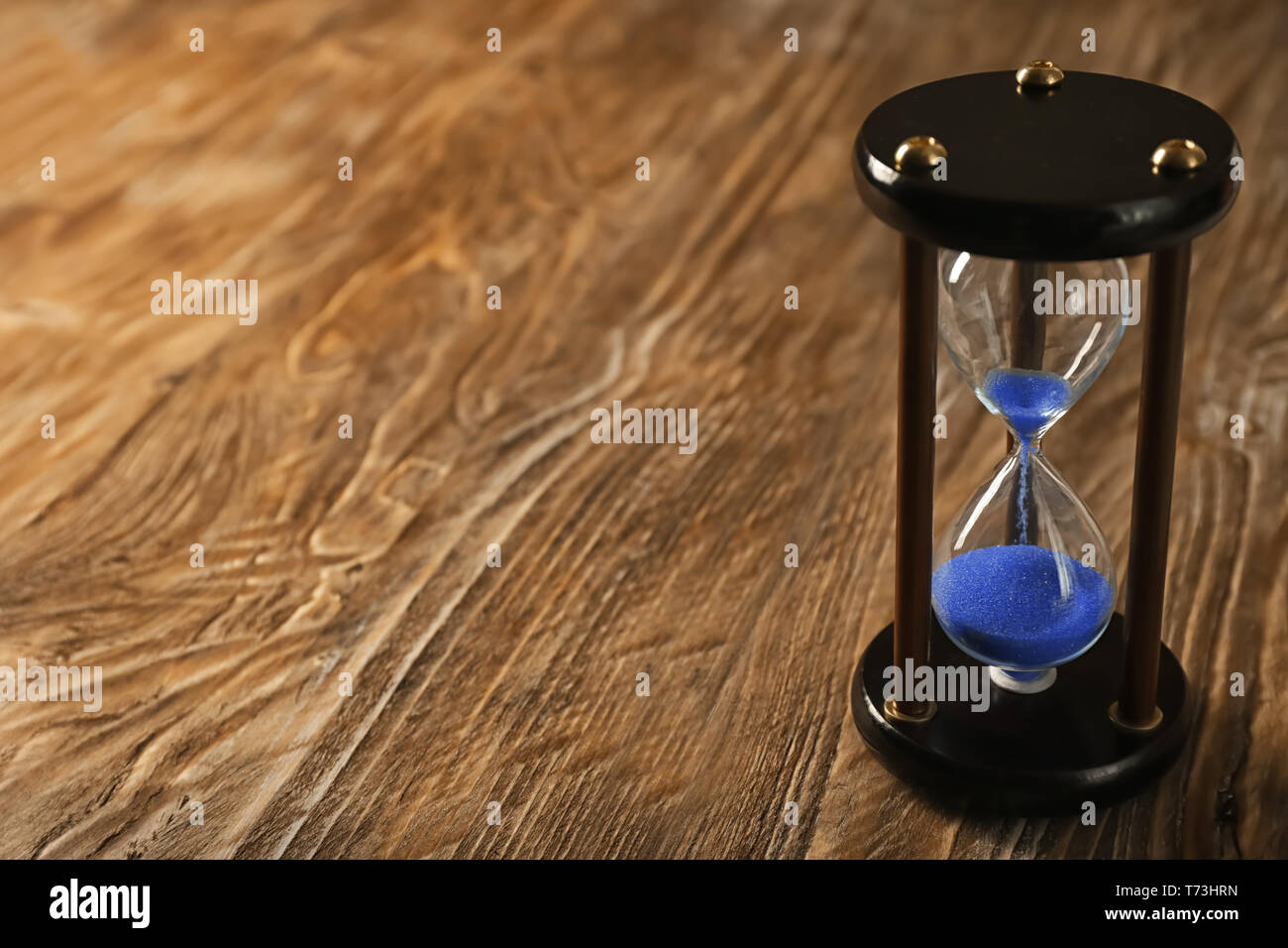 Hourglass on wooden background. Time management concept Stock Photo - Alamy