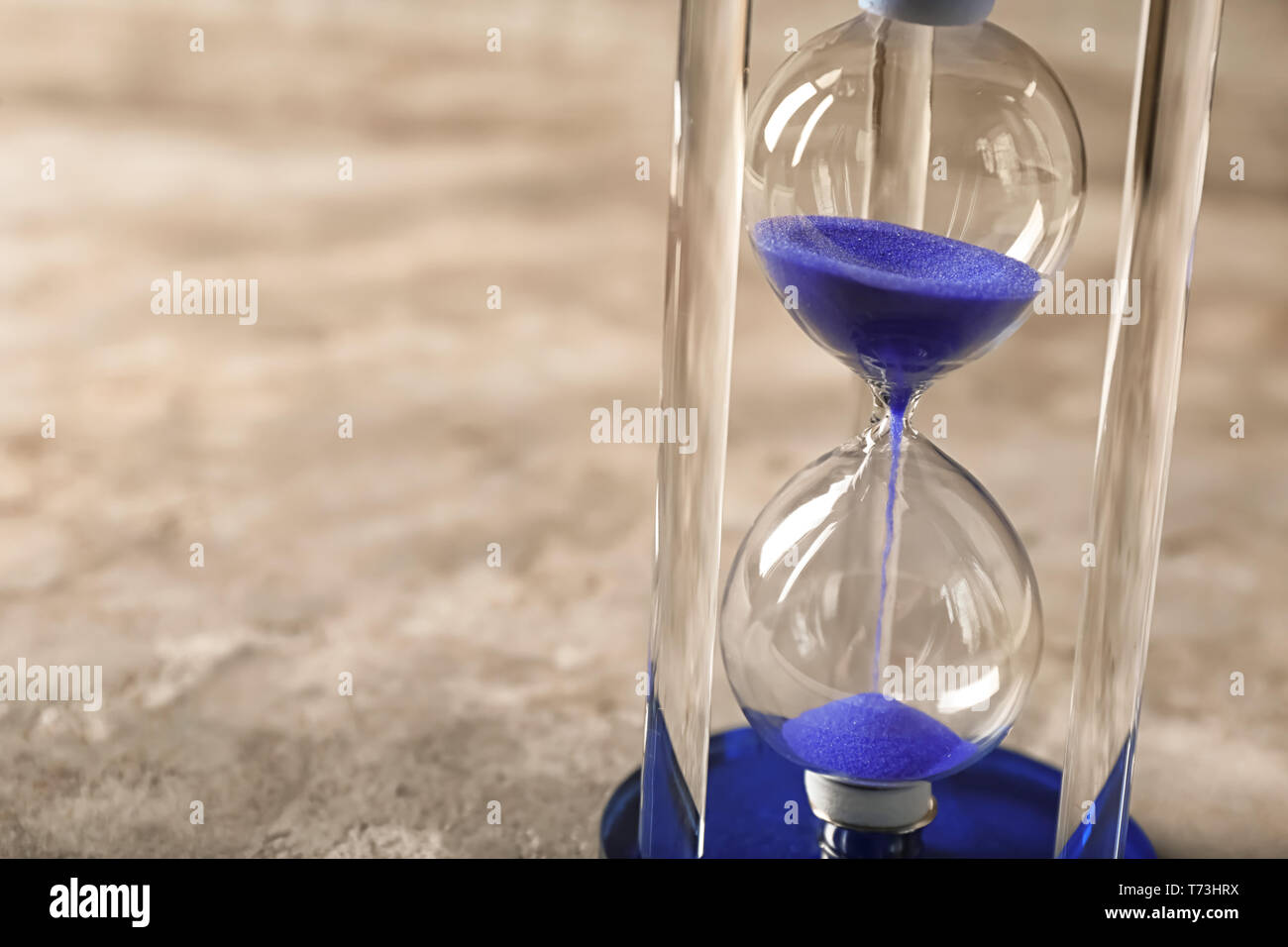 Hourglass on gray background. Time management concept Stock Photo - Alamy