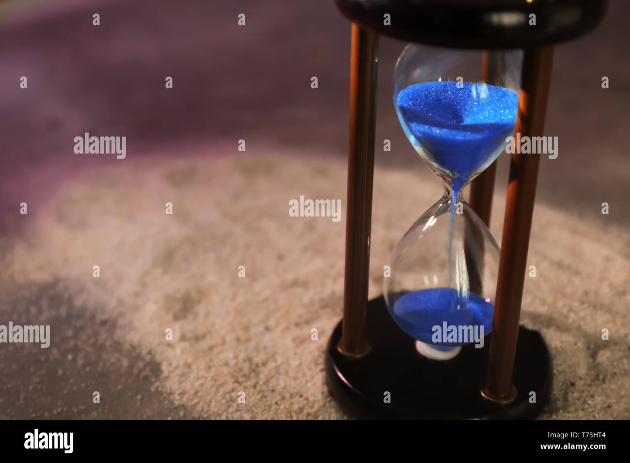 Hourglass on sand. Time management concept Stock Photo - Alamy
