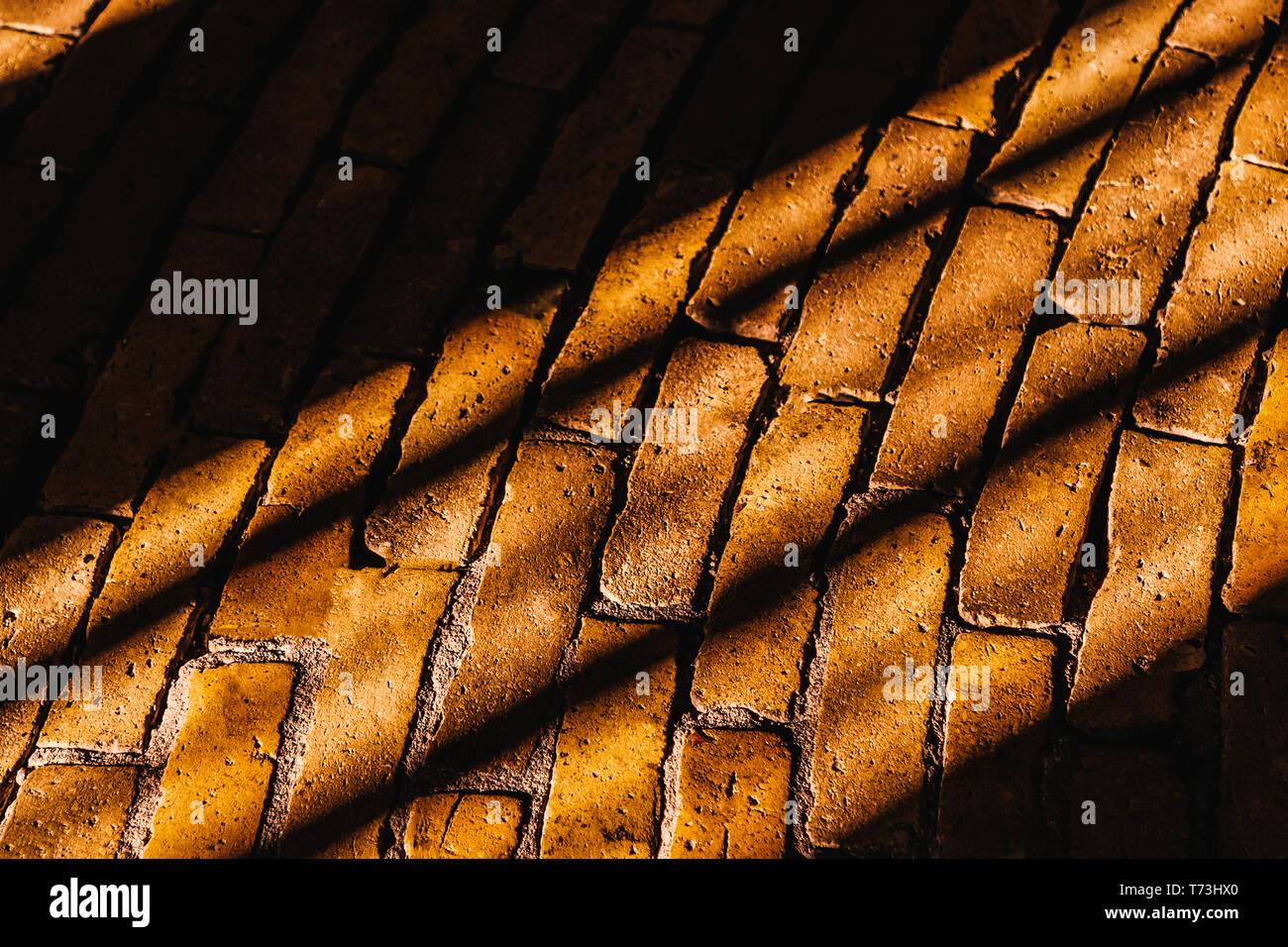Sun rays and shadows in the old terracotta brick road Stock Photo - Alamy