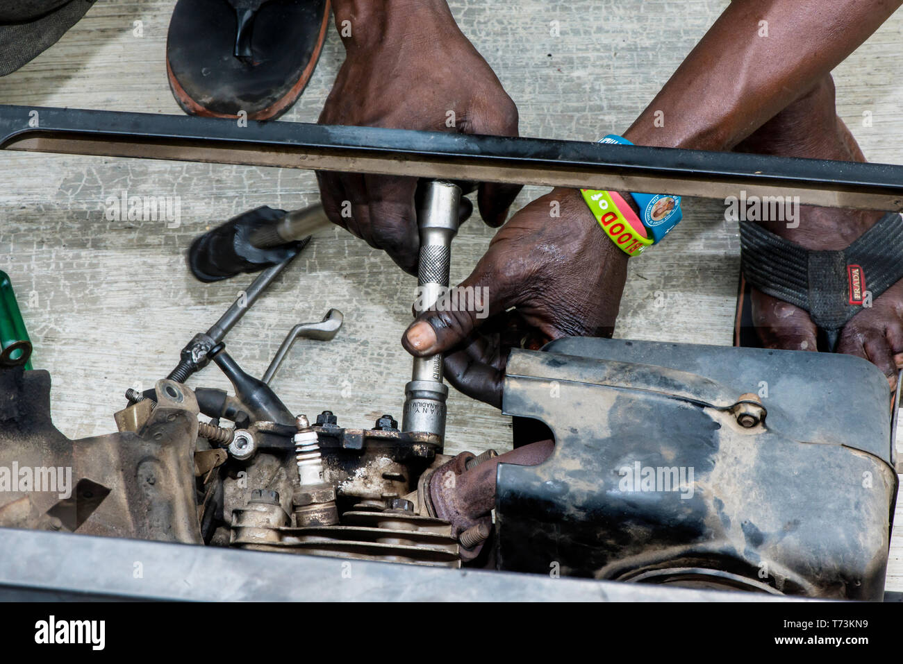 Black Hands working on different machine parts Stock Photo - Alamy
