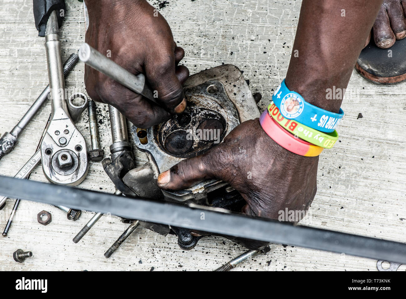 Black Hands working on different machine parts Stock Photo - Alamy