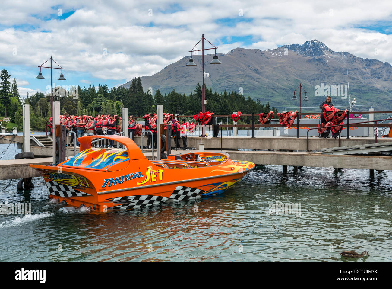Tourists waiting for the jet boat loading at a Queenstown pier ...