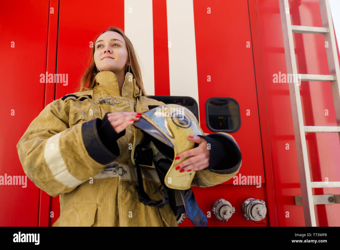 Image of girl fire looking on side of standing at fire truck at station ...
