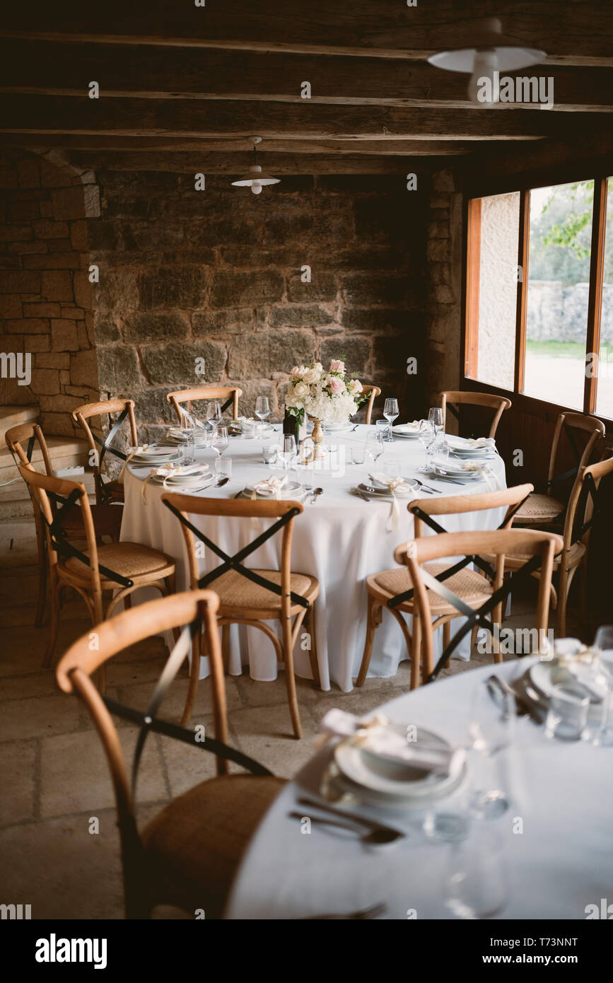 Table setting at wedding reception in old stone villa Stock Photo - Alamy
